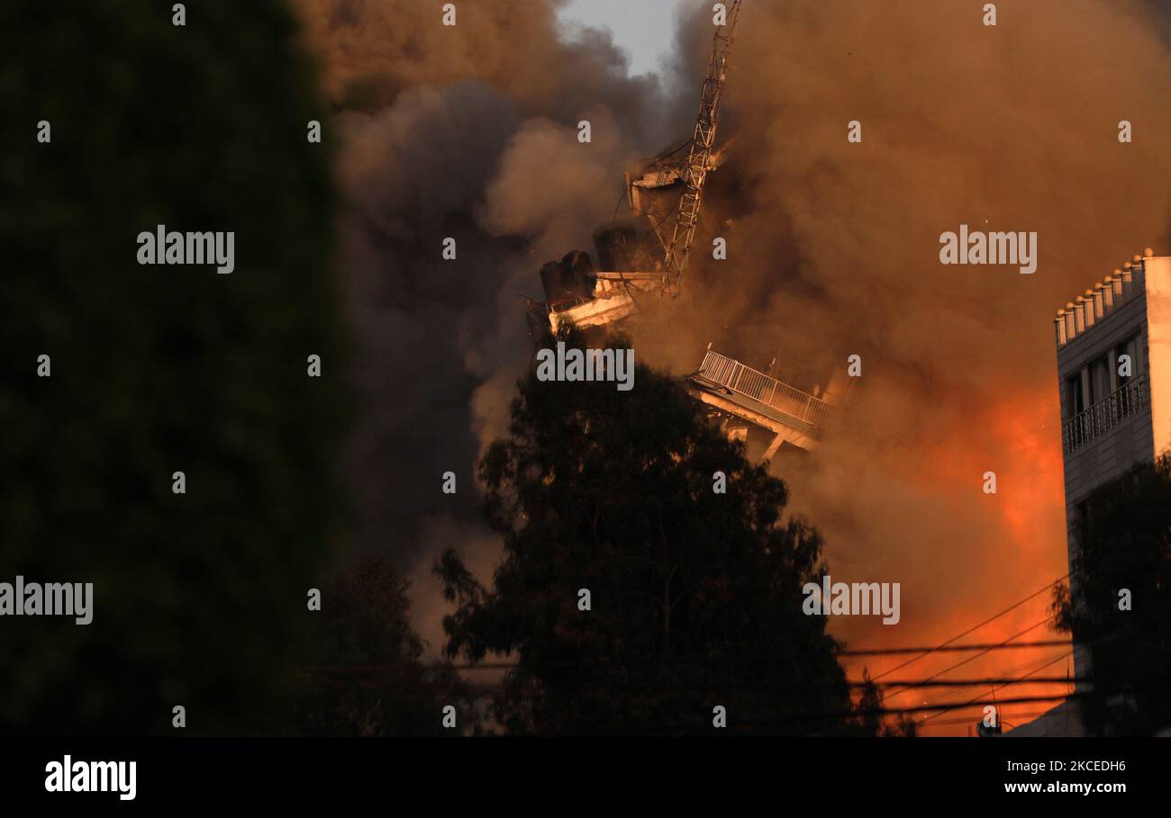 Smoke and flames rise from a tower building as it is destroyed by ...