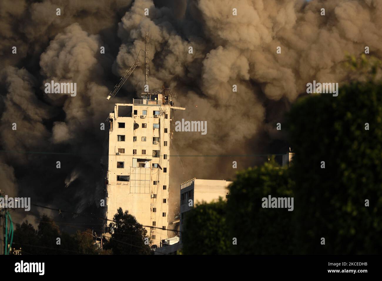Smoke and flames rise from a tower building as it is destroyed by ...