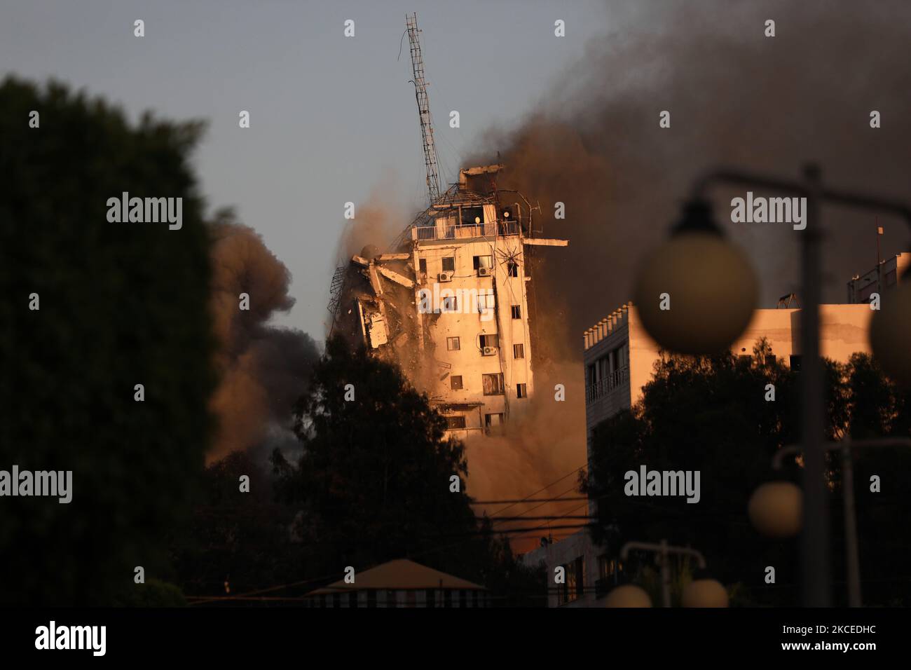 Smoke and flames rise from a tower building as it is destroyed by ...
