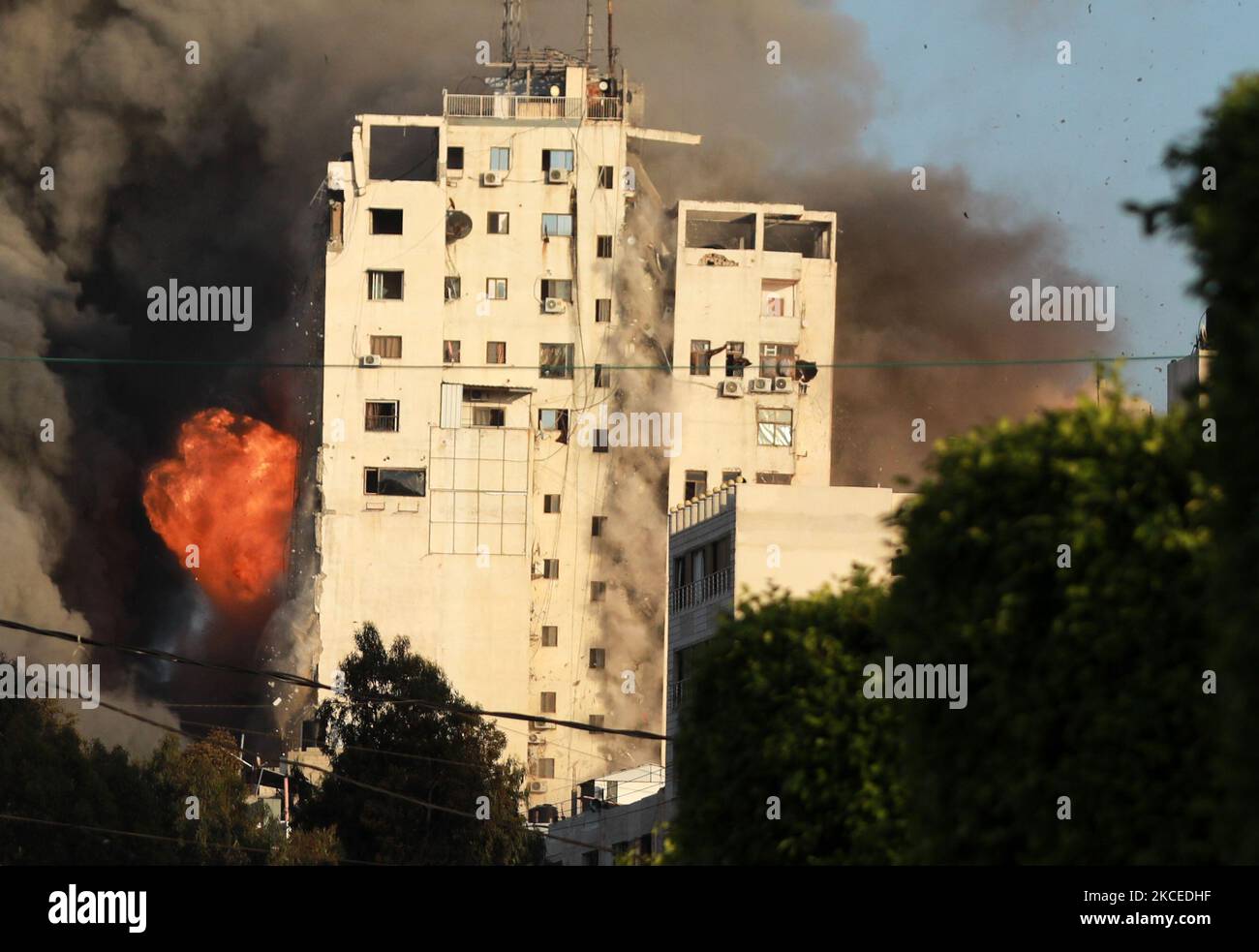 Smoke and flames rise from a tower building as it is destroyed by ...