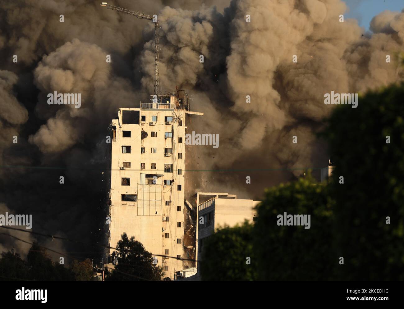 Smoke and flames rise from a tower building as it is destroyed by ...
