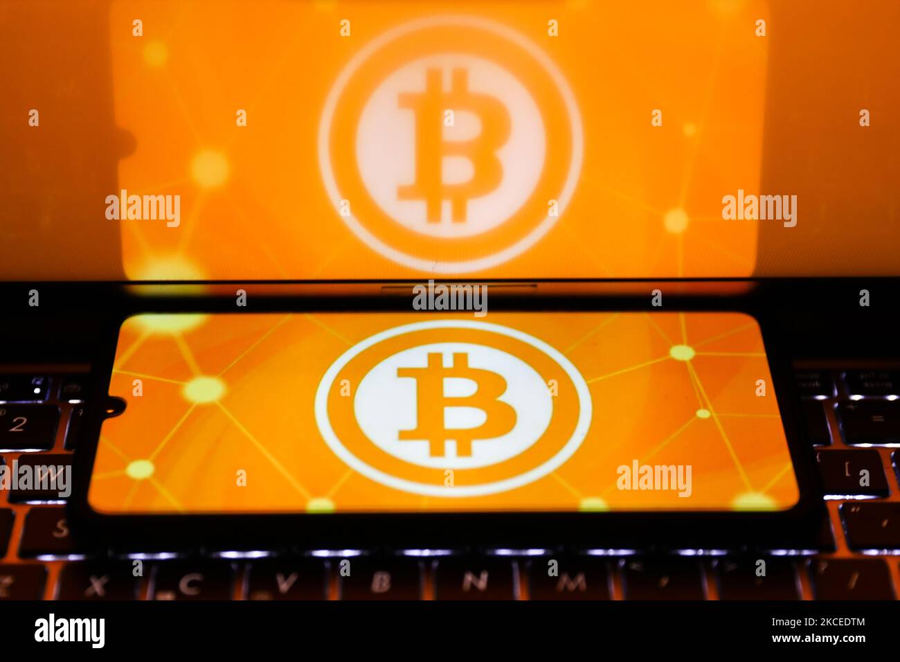 Bitcoin cryptocurrency logo is displayed on a mobile phone screen ...