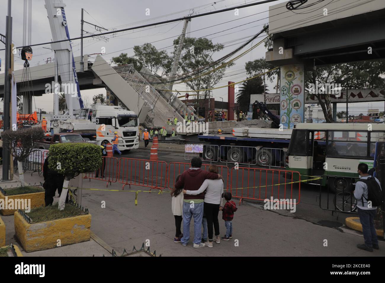 Passers-by watch emergency work and debris removal at ground zero ...