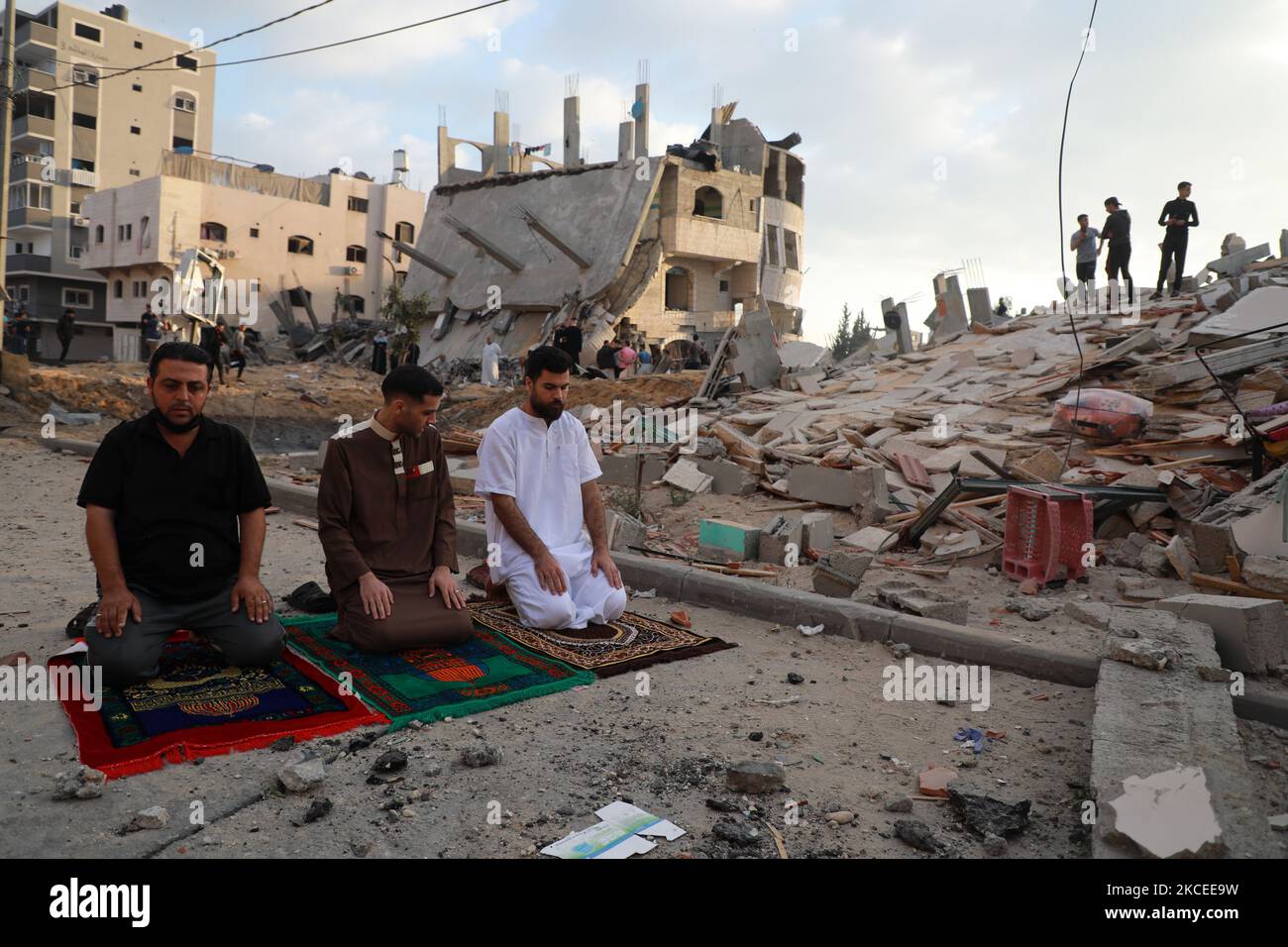 Palestinian Muslim men perform the morning Eid Al-Fitr prayer outdoors ...