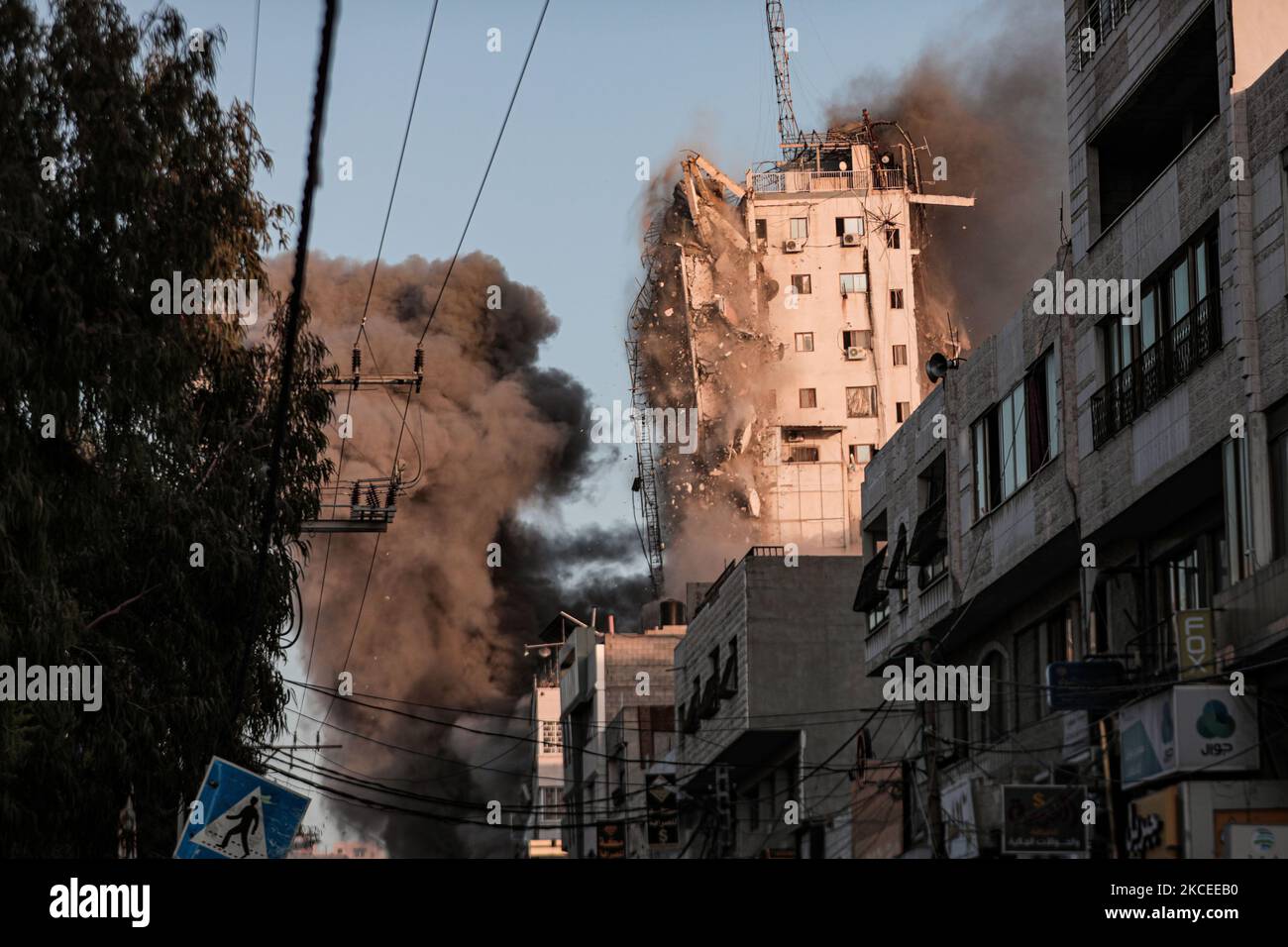 Smoke and flames rise from a tower building as it is destroyed by ...