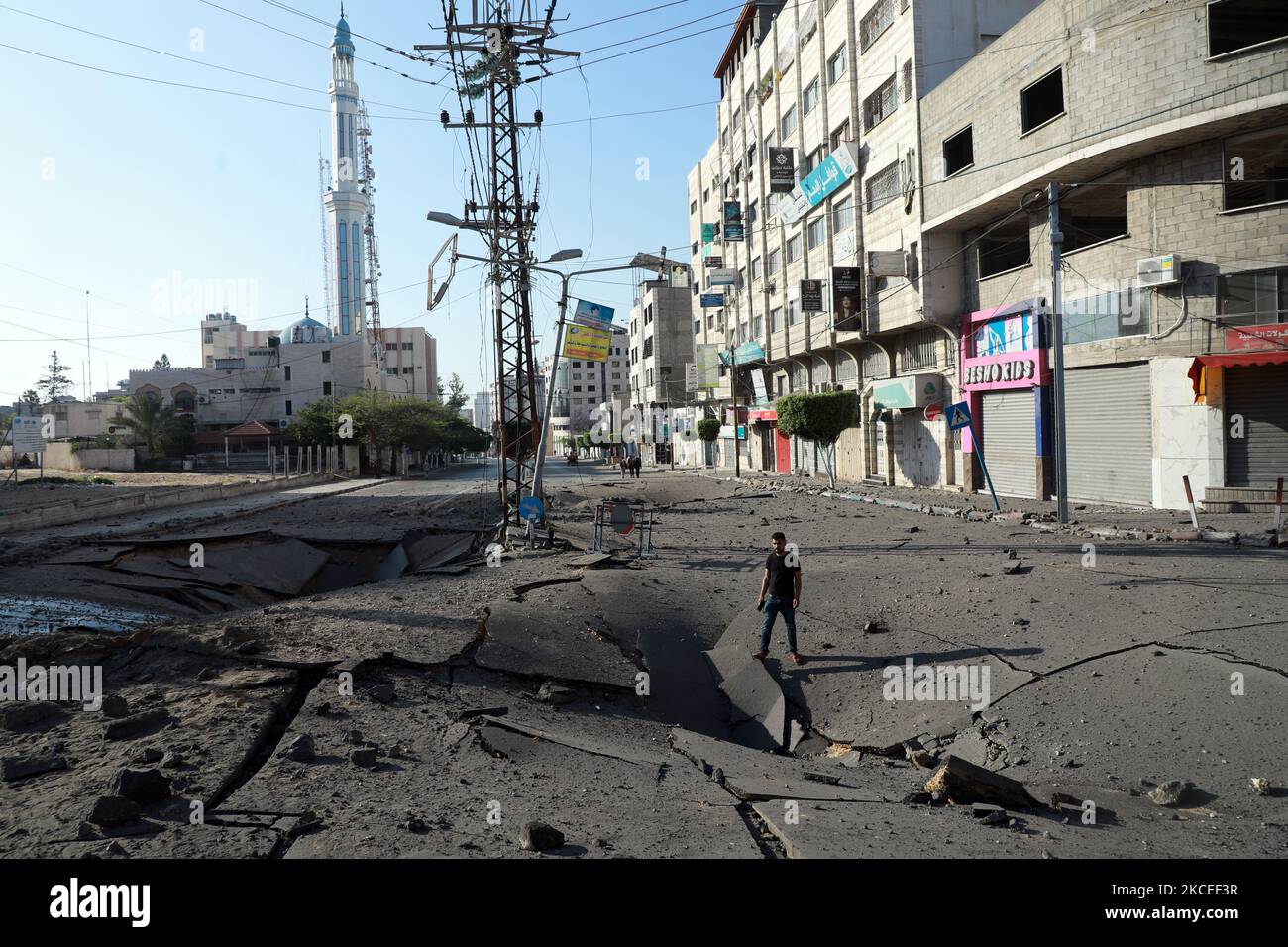 People look at the street a day after Israeli airstrike hit the city in ...