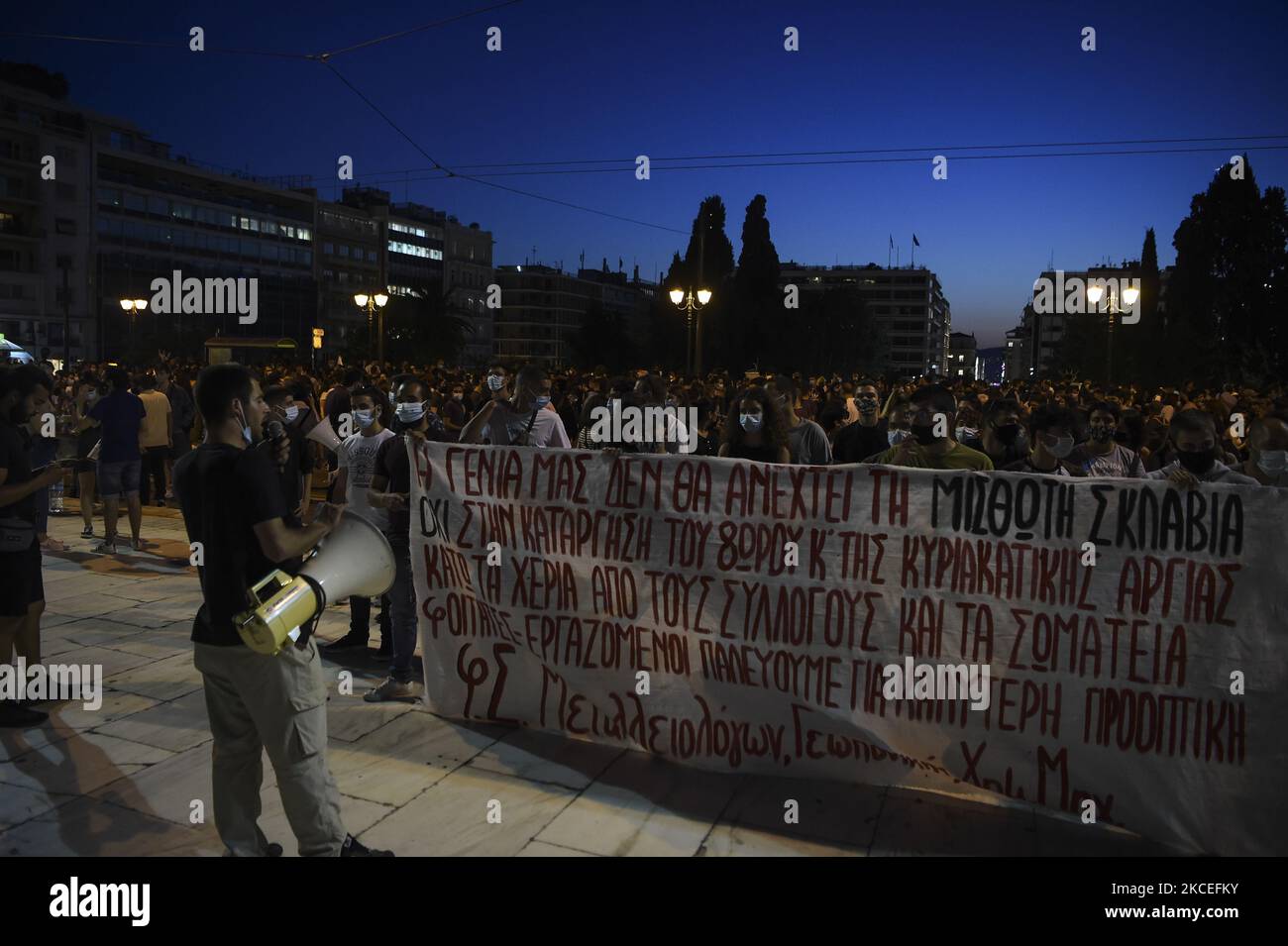 Demonstrators of the Greek Labour Union (PAME) hold a banner as they ...
