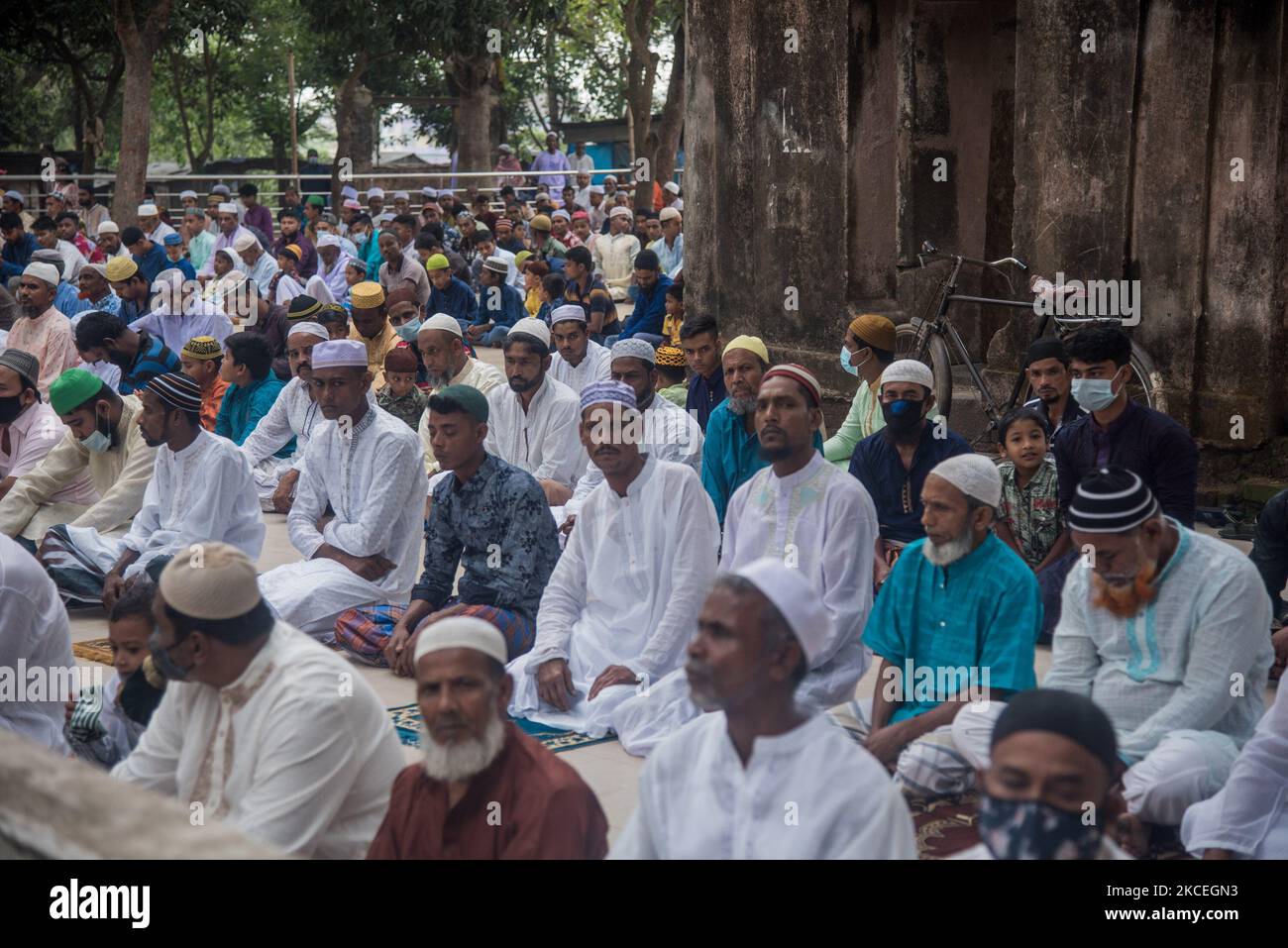 People are praying outside of a mosque at Bogra in Bangladesh on May 14 ...