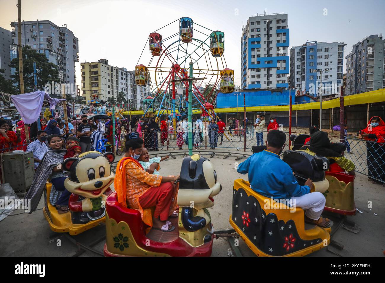 Children enjoy a ride at an makeshift amusement park during Eid al Fitr ...
