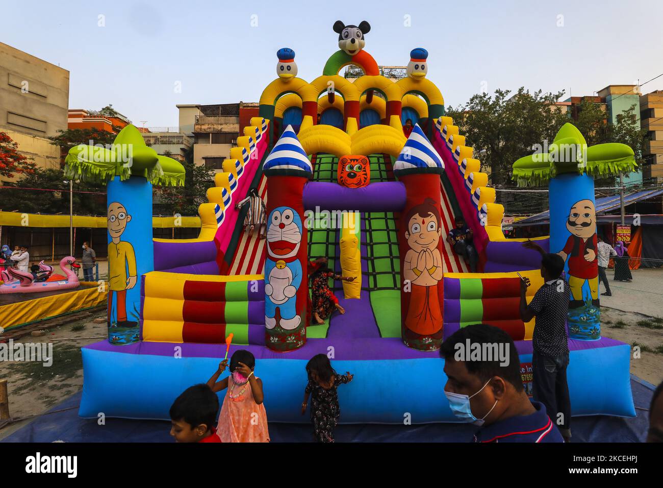 Children enjoy a ride at an makeshift amusement park during Eid al Fitr ...