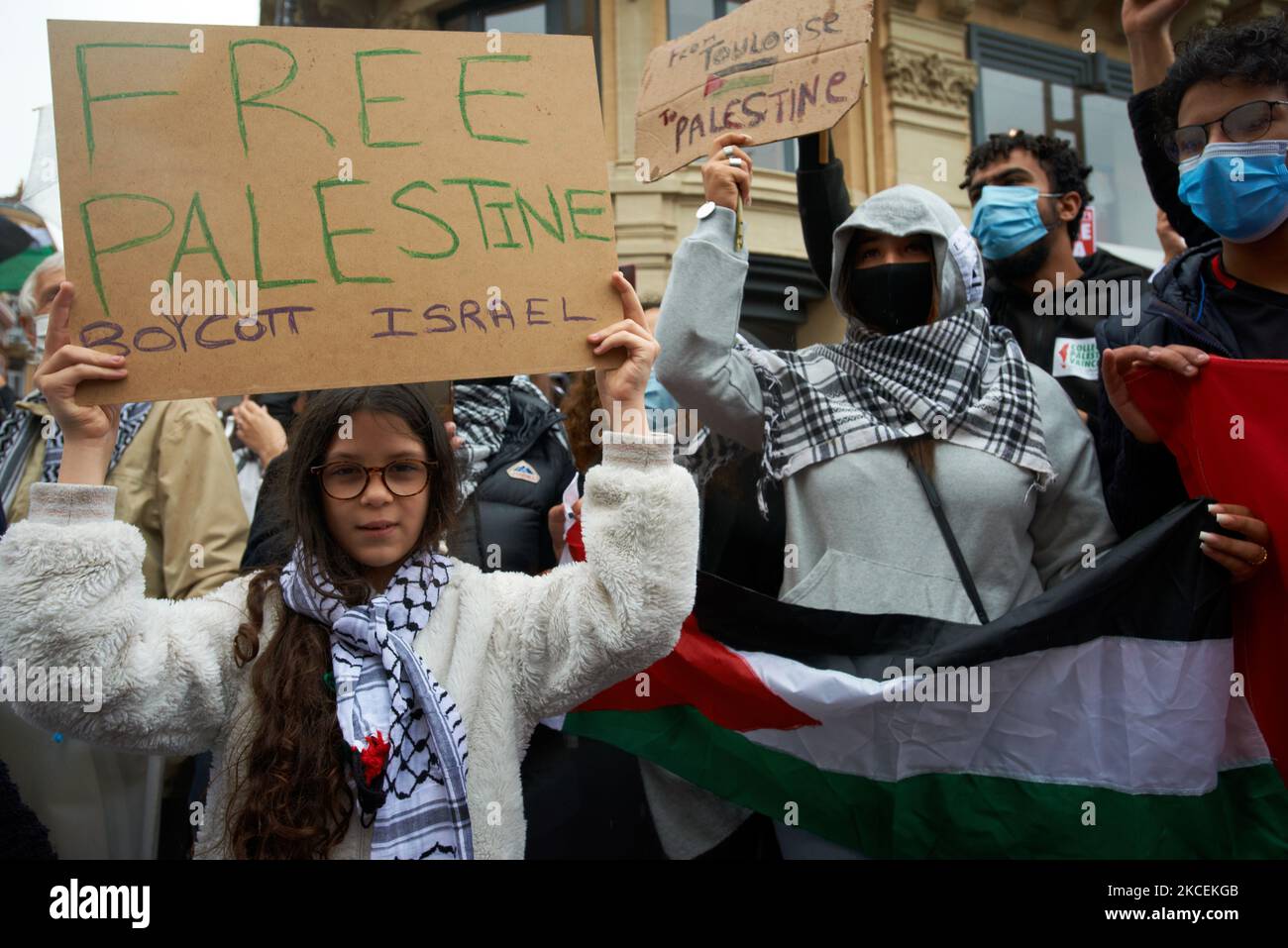 A girl holds a placard reading 'Free Palestine, boycott Israel' during ...