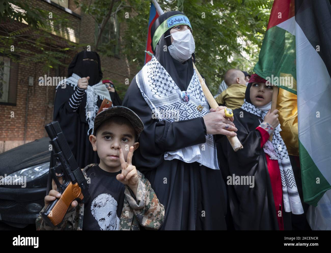 An Azeri young boy wearing a military uniform and a T-shirt with a ...