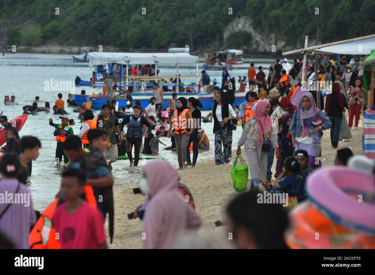 Local tourists crowd the Tanjung Karang beach tourism area without ...