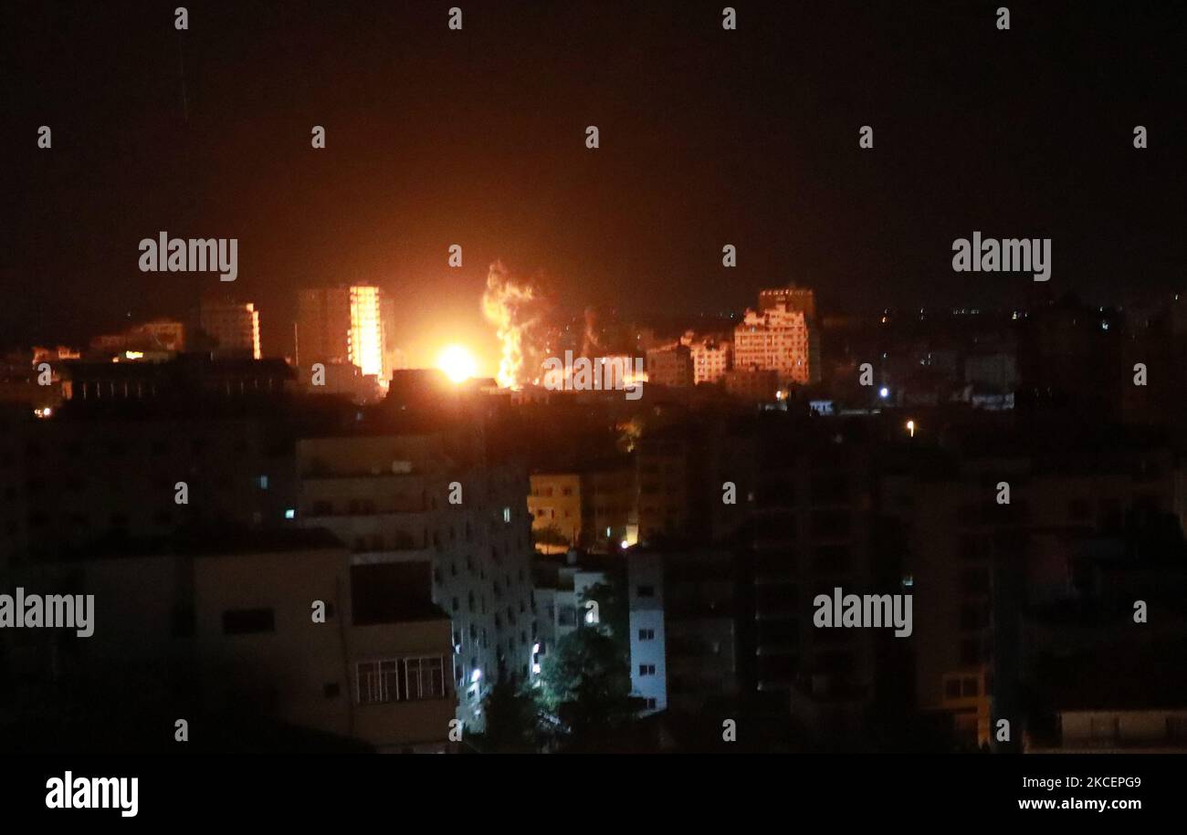 A ball of fire and a plume of smoke rise above buildings in Gaza City ...