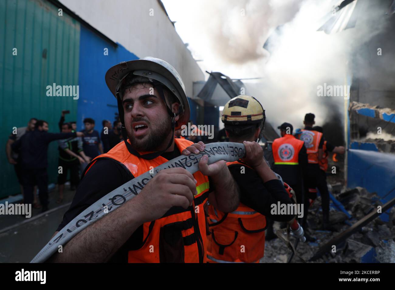 Palestinian firefighters douse a huge fire at the Foamco mattrss ...