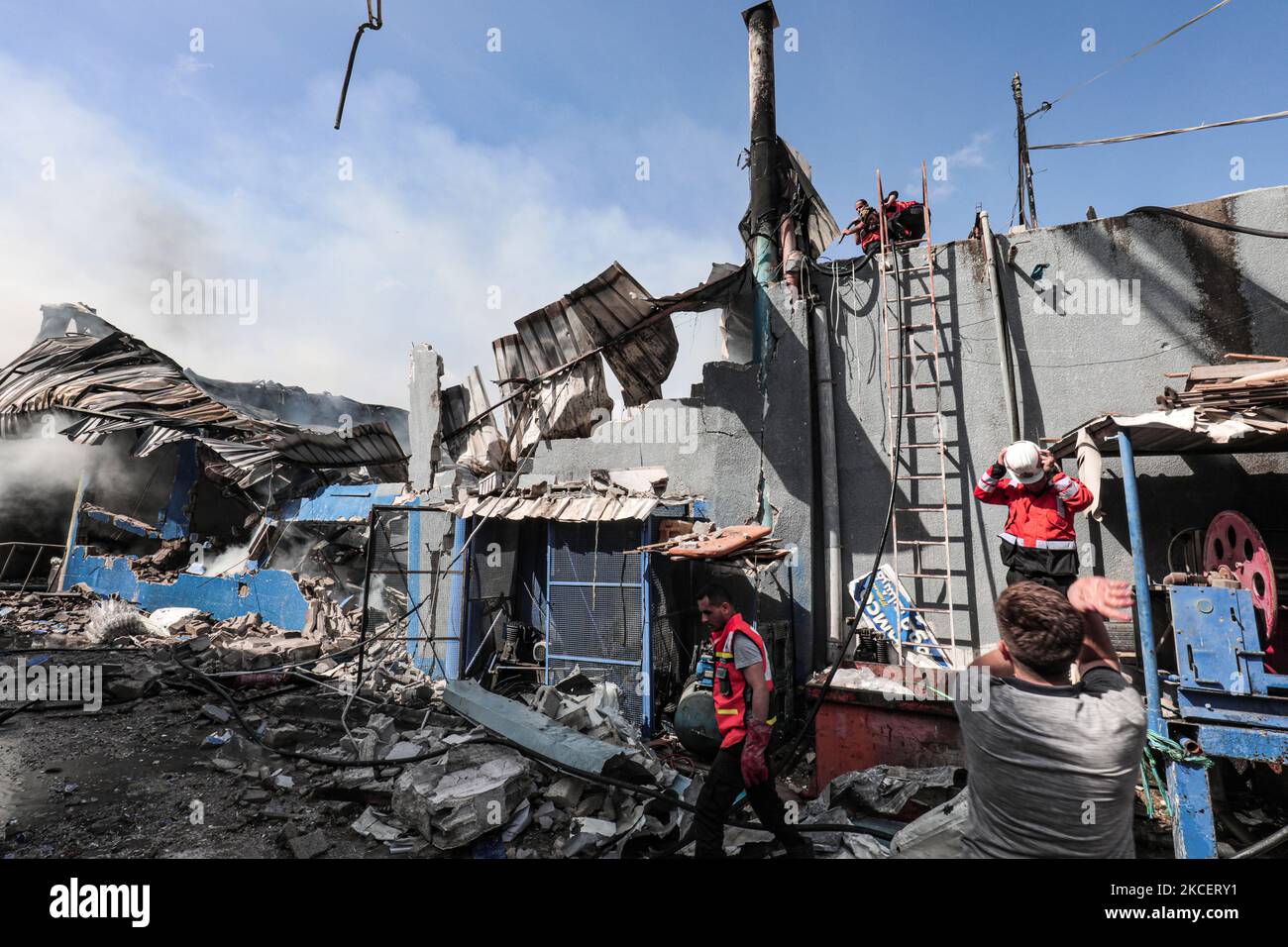 Palestinian firefighters douse a huge fire at the Foamco mattrss ...