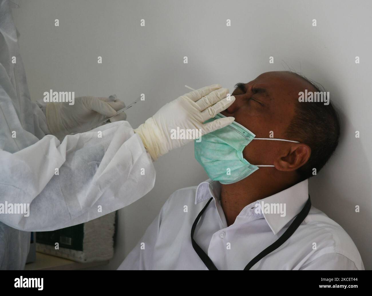 Health workers carry out antigen test swabs to all employees of the ...