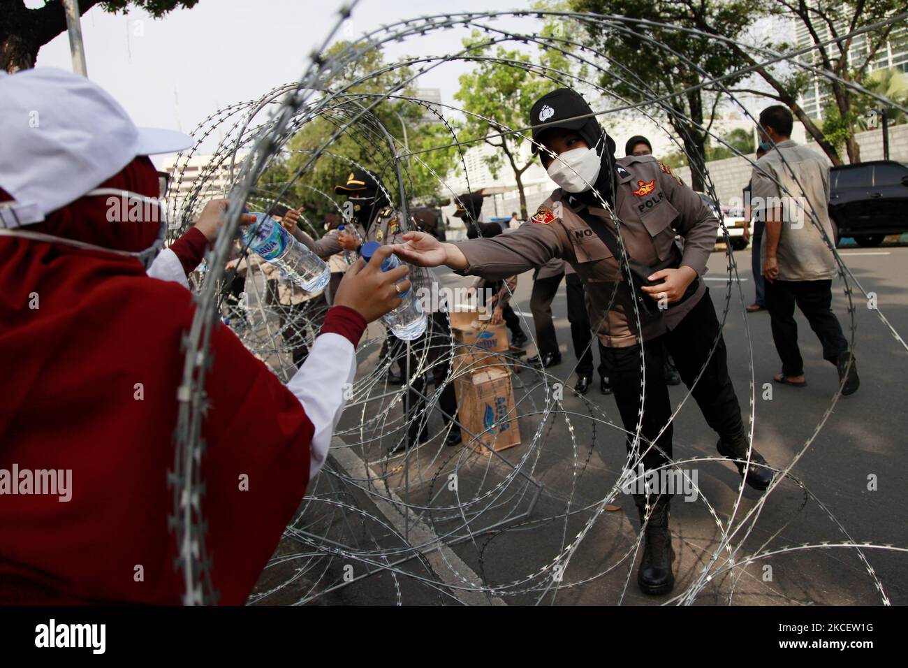 Police officers gives mineral waters to demonstrans during a ...