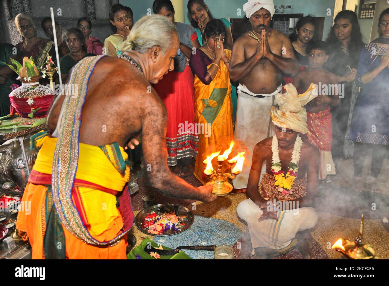 Tamil Hindu priest performs special prayers during the 108 abhishekam ...