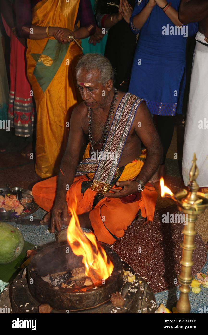 Tamil Hindu priest performs special prayers during the 108 abhishekam ...