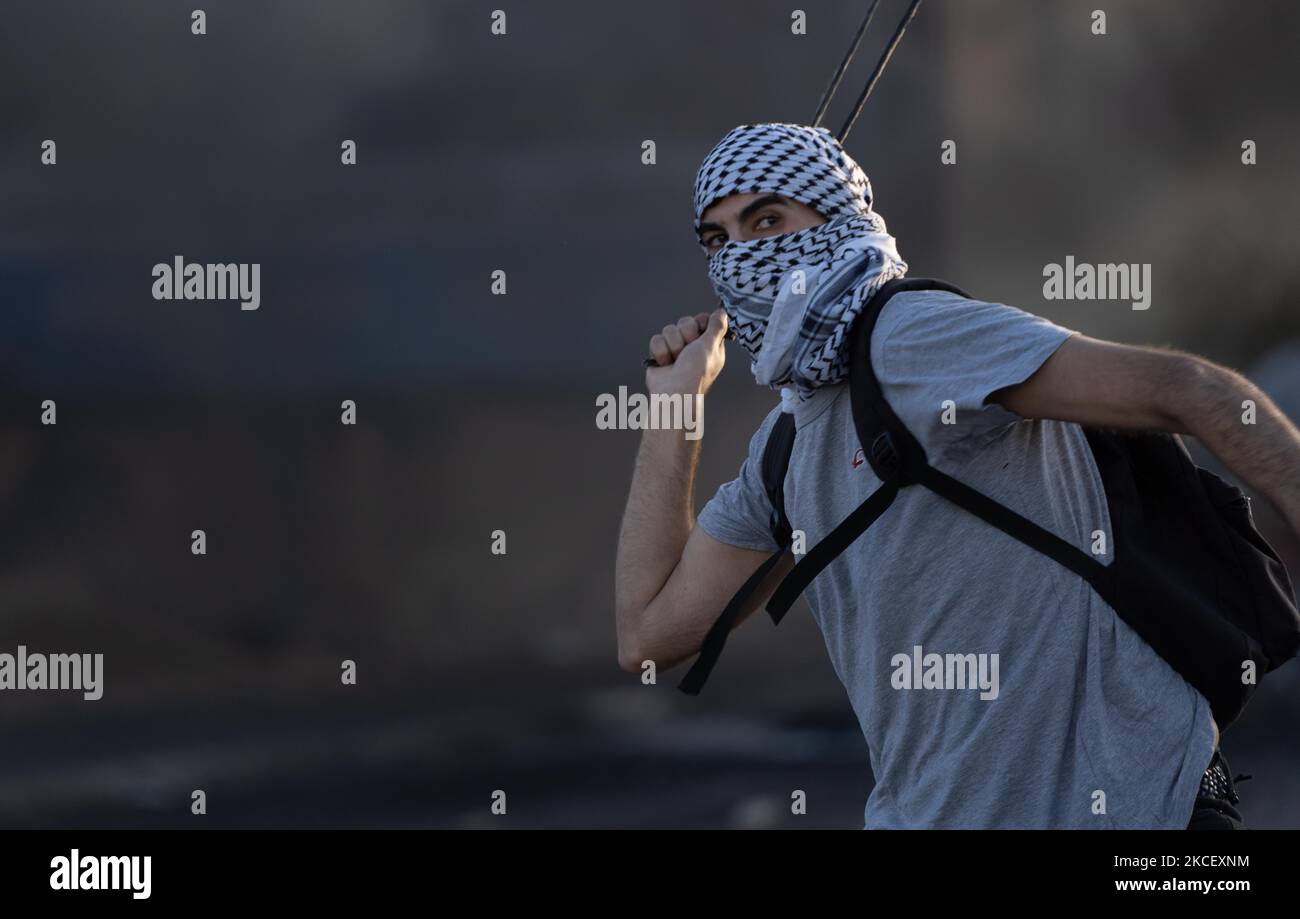 A Palestinian protester uses a slingshot to throw stones at Israeli ...