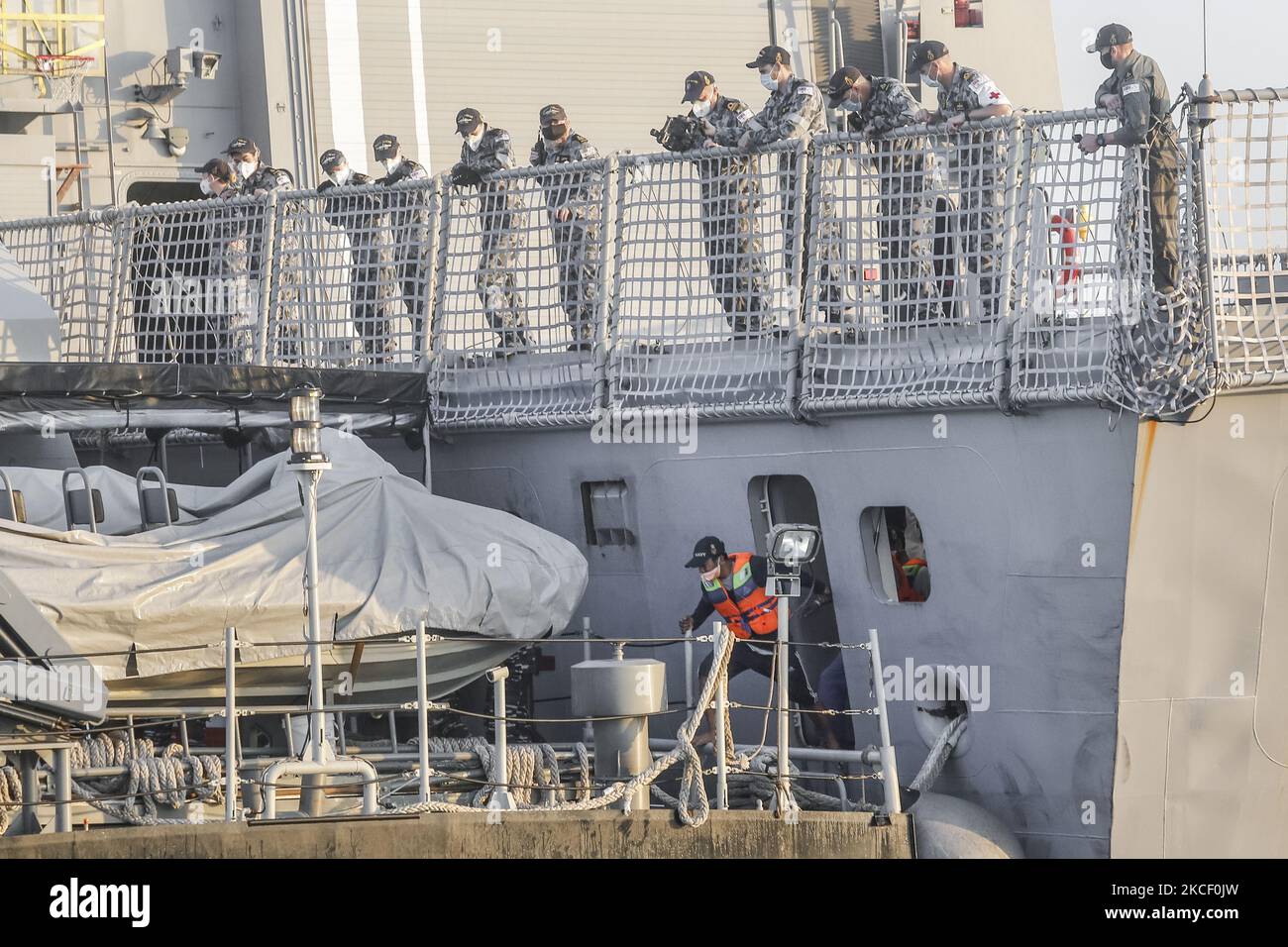 Indonesian fishermen transferred to Navy ship KRI Escolar (left) from ...