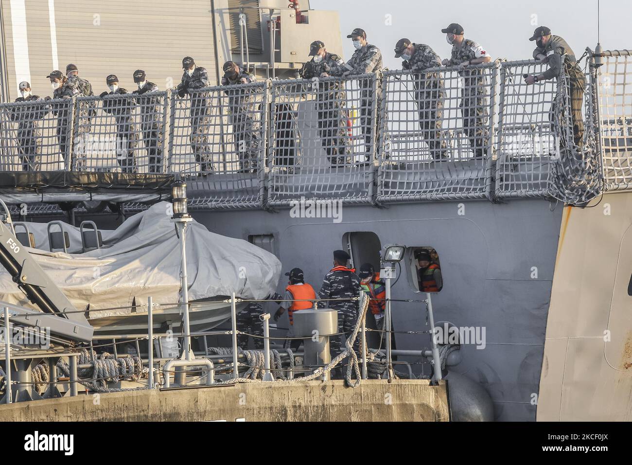 Indonesian fishermen transferred to Navy ship KRI Escolar (left) from ...
