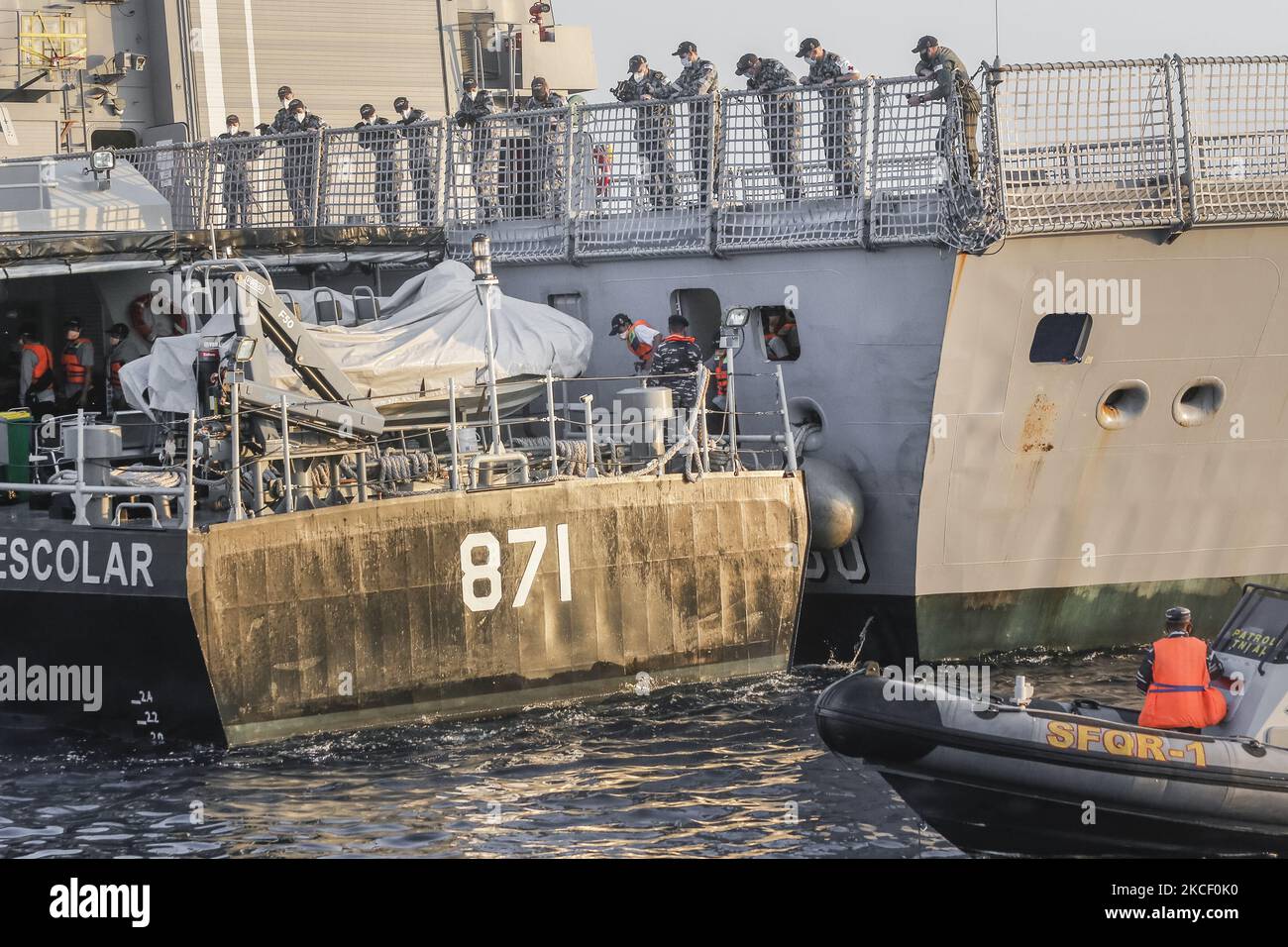 Indonesian fishermen transferred to Navy ship KRI Escolar (left) from ...