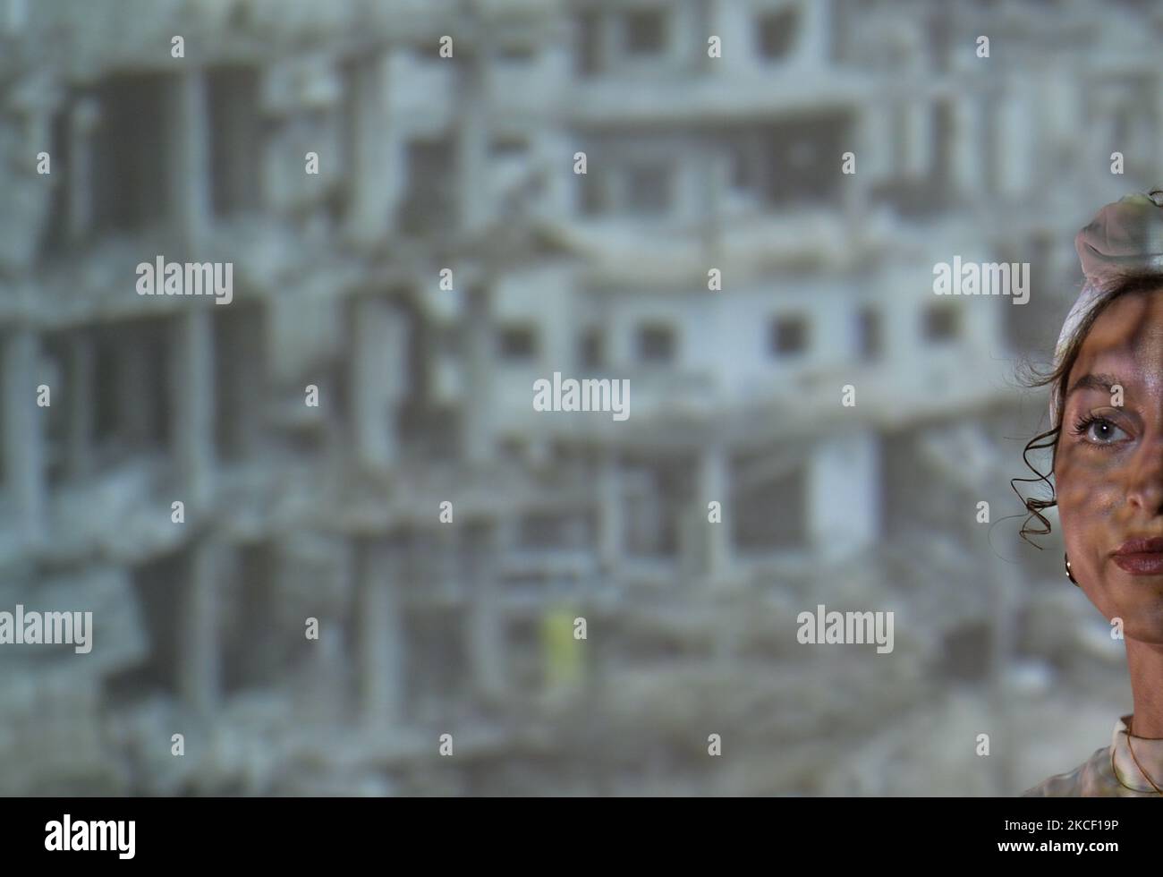 Libyan-Irish singer Farah Elle seen with images of the Libyan war in ...