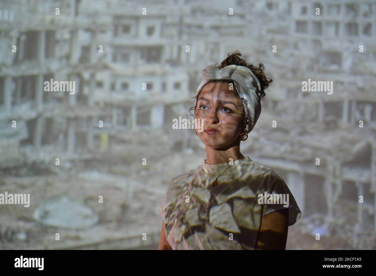 Libyan-Irish singer Farah Elle seen with images of the Libyan war in ...