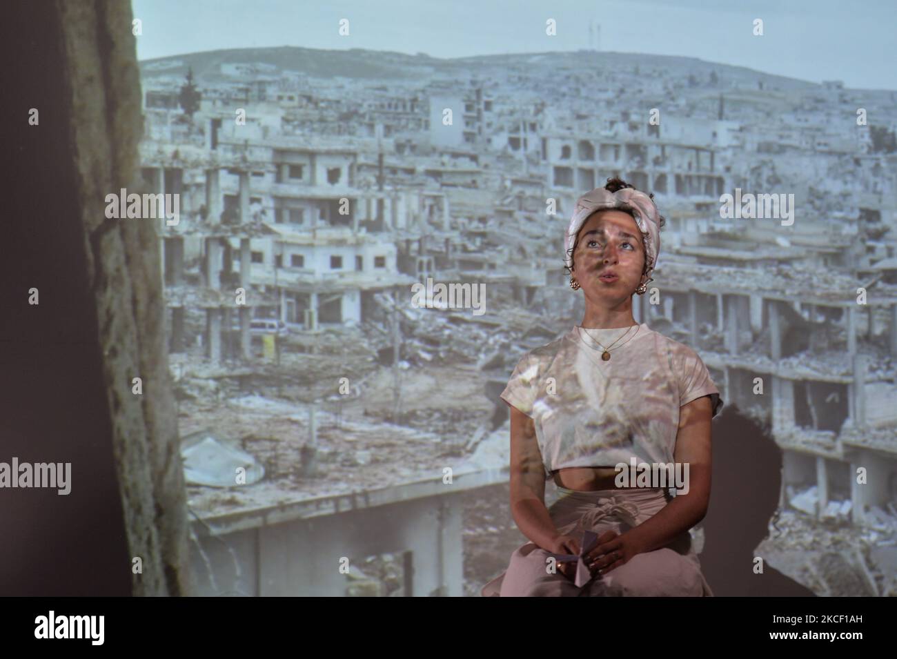 Libyan-Irish singer Farah Elle seen with images of the Libyan war in ...
