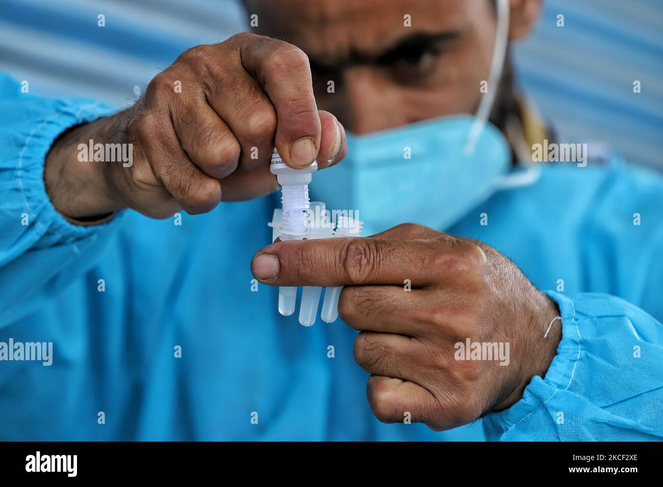 Health workers wearing PPE kit collects Nasal Swab Sample from people ...