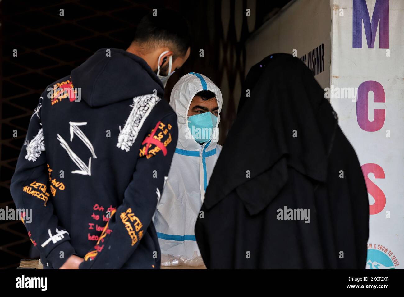 Health workers wearing PPE kit collects Nasal Swab Sample from people ...