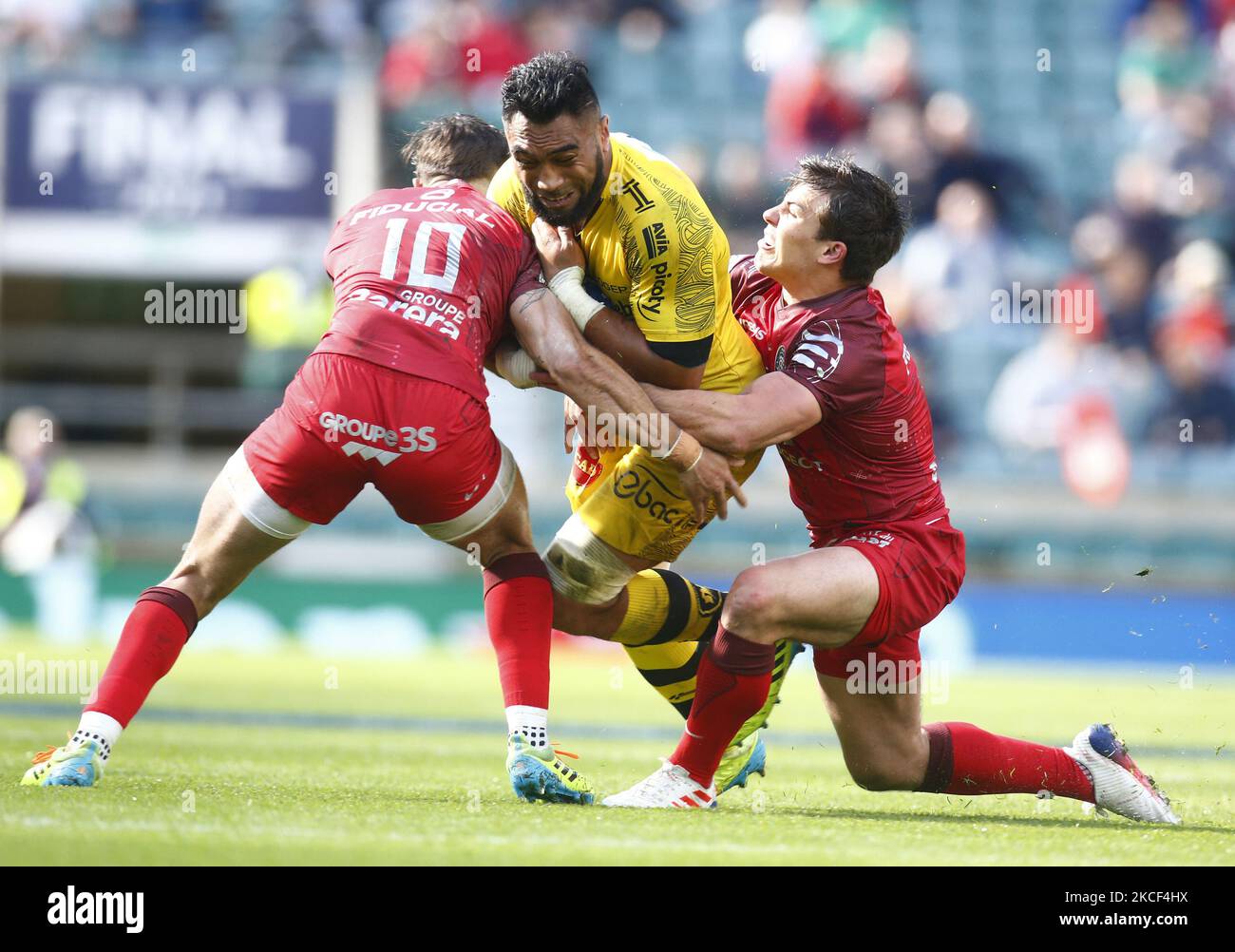 Victor Vito of La Rochelle gets tackled by Romain Ntamack of Toulouse ...