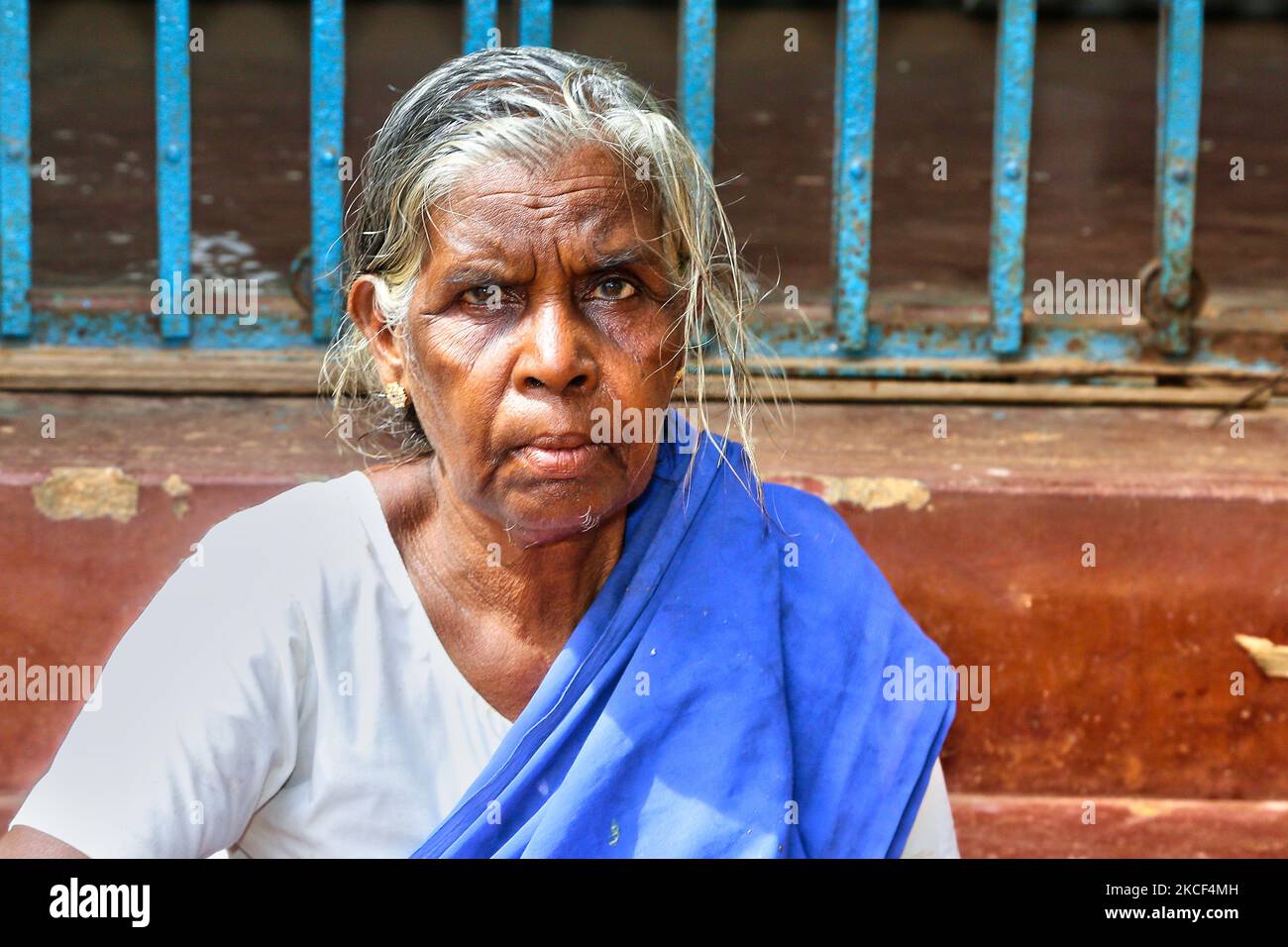 Elderly Tamil woman outside her home in the Sokkankudiaruppu Village in ...