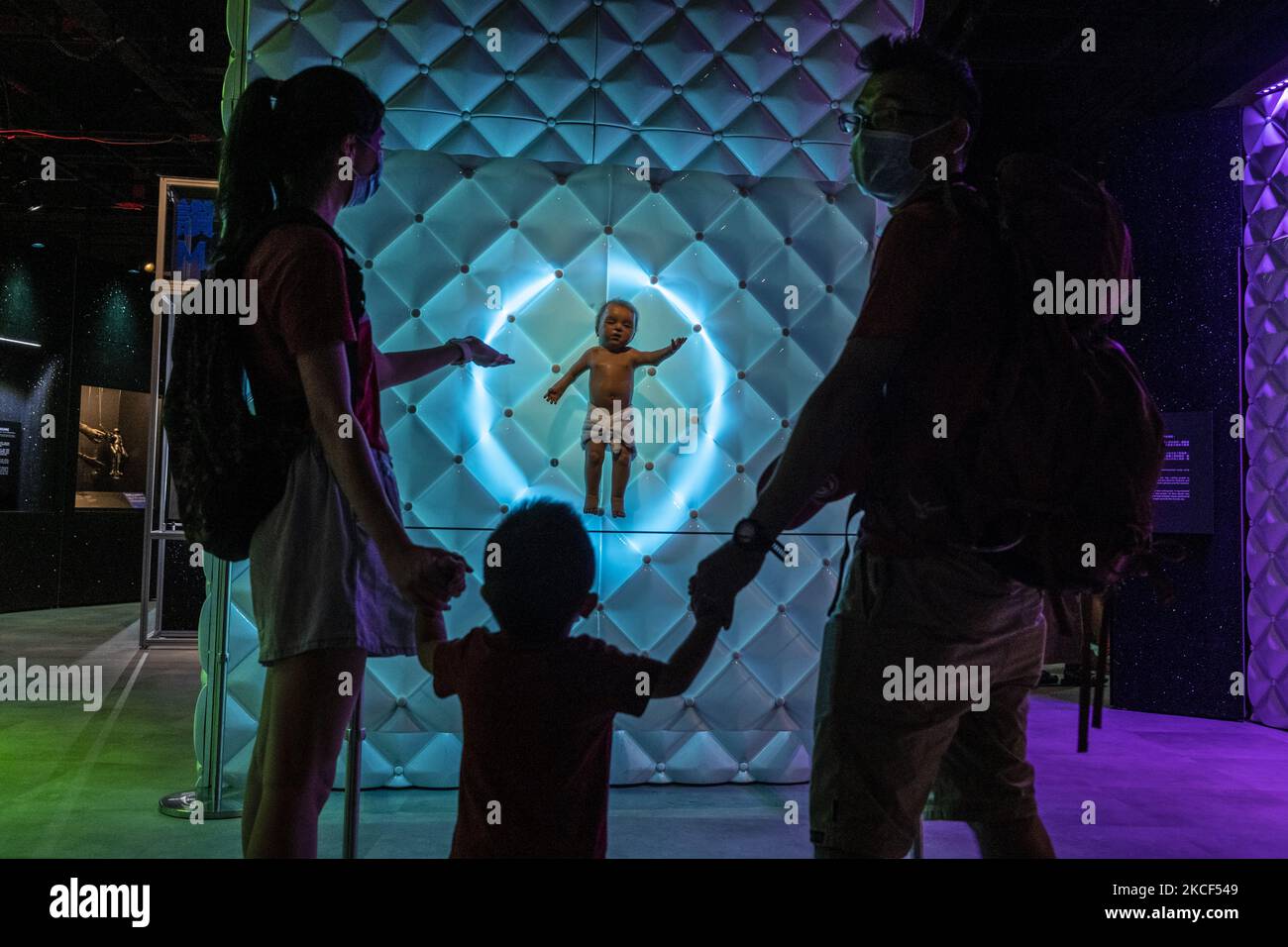 Visitors look at the robot "Animatronic baby" at the exhibition "Robots ...