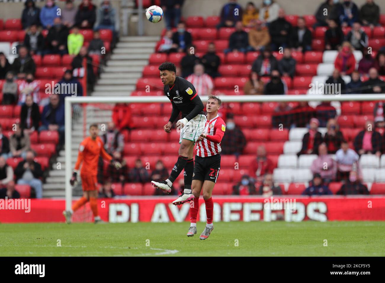 Morgan Rogers of Lincoln City wins a header against Jack Diamond during ...