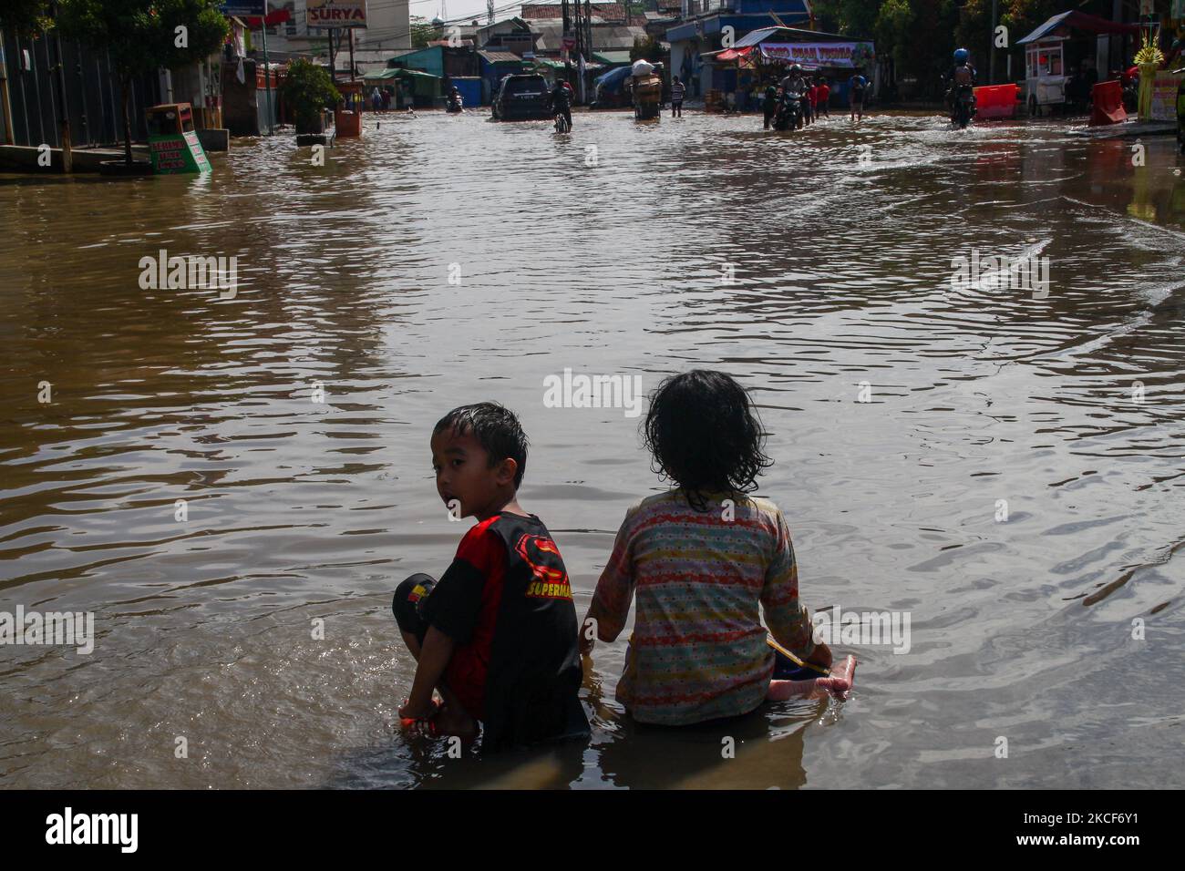 Kids is seen play when the flood submerged on May, 25 2021 at Baleendah ...