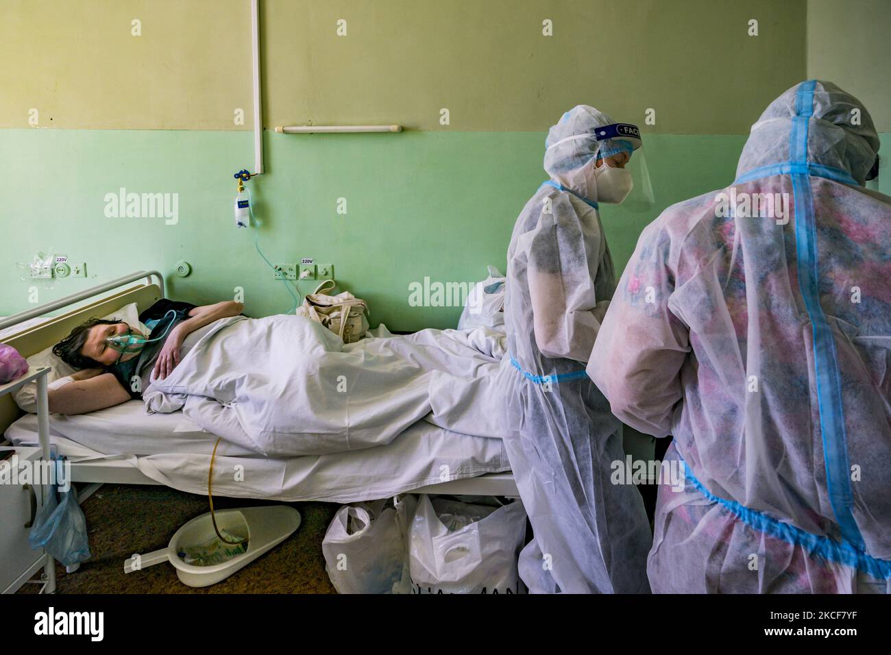 Health workers with personal protection equipment care a covid-19 ...