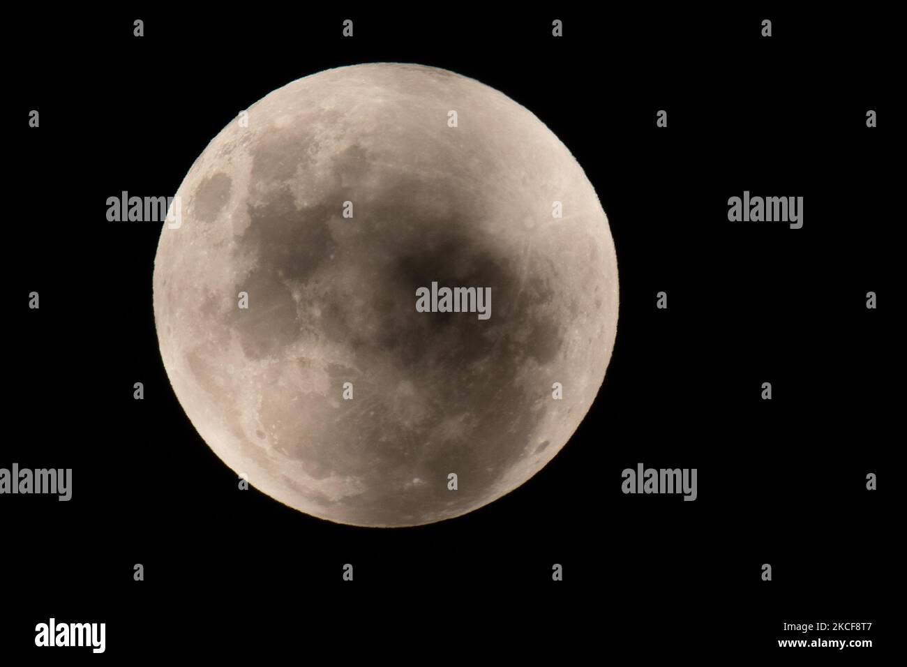 The moon is seen prior to the partial lunar eclipse from Sydney CBD on ...