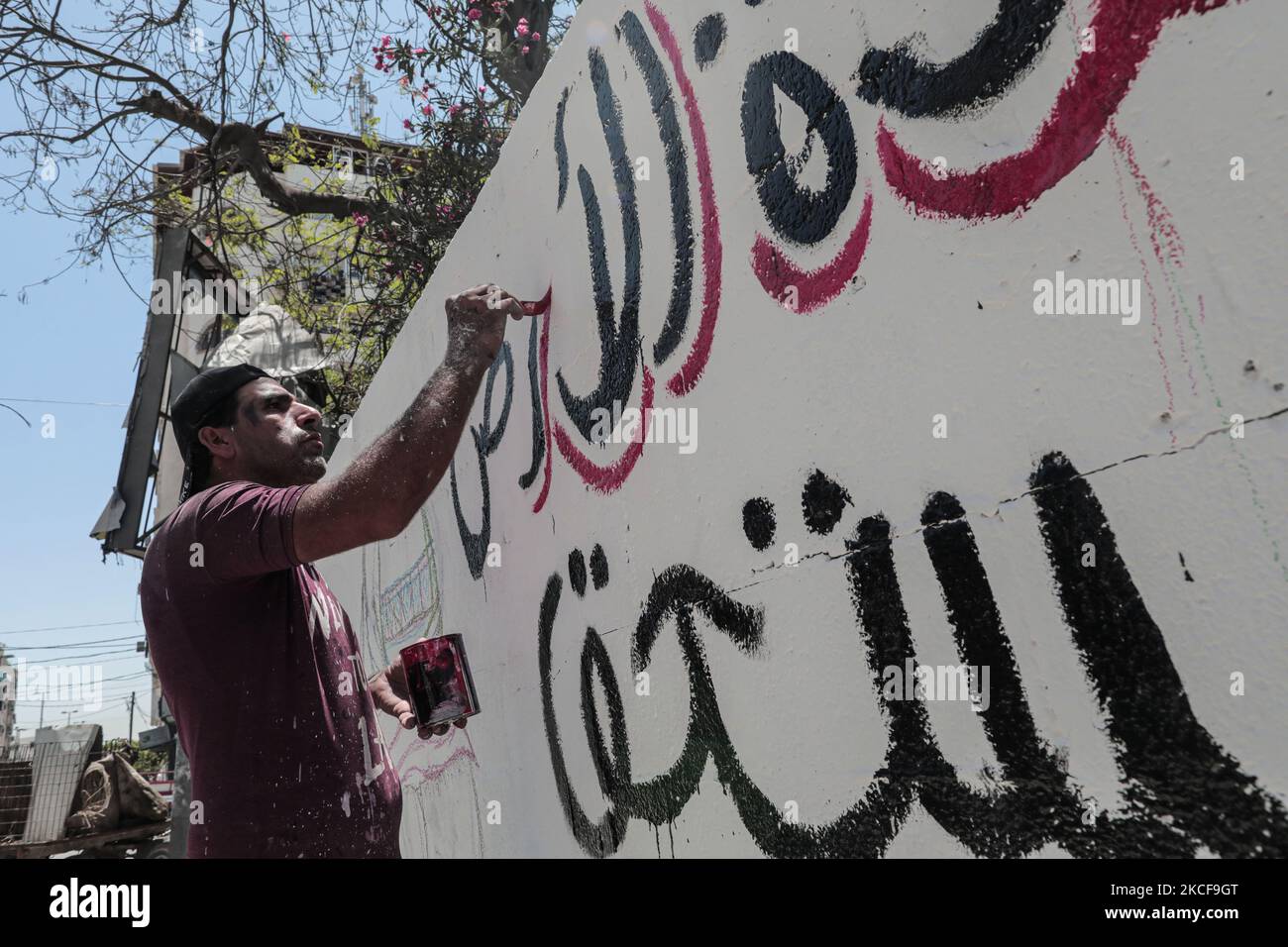 Palestinian artists paint and write words on the walls for Palestine ...