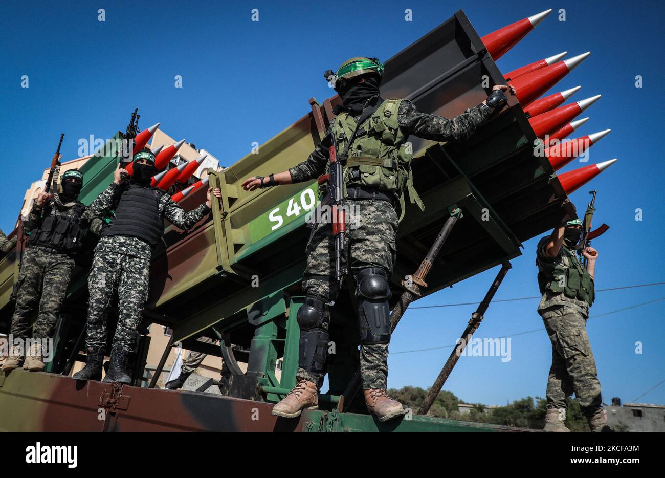Palestinian Hamas militants attend an anti-Israel rally in Khan Younis ...