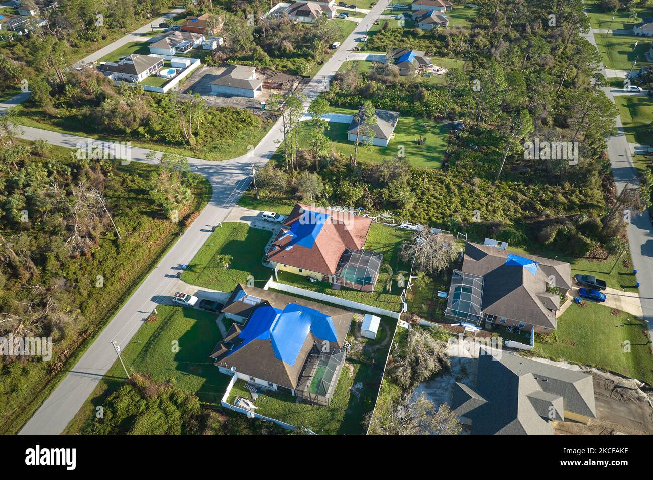 Hurricane Ian damaged house rooftop covered with protective plastic ...
