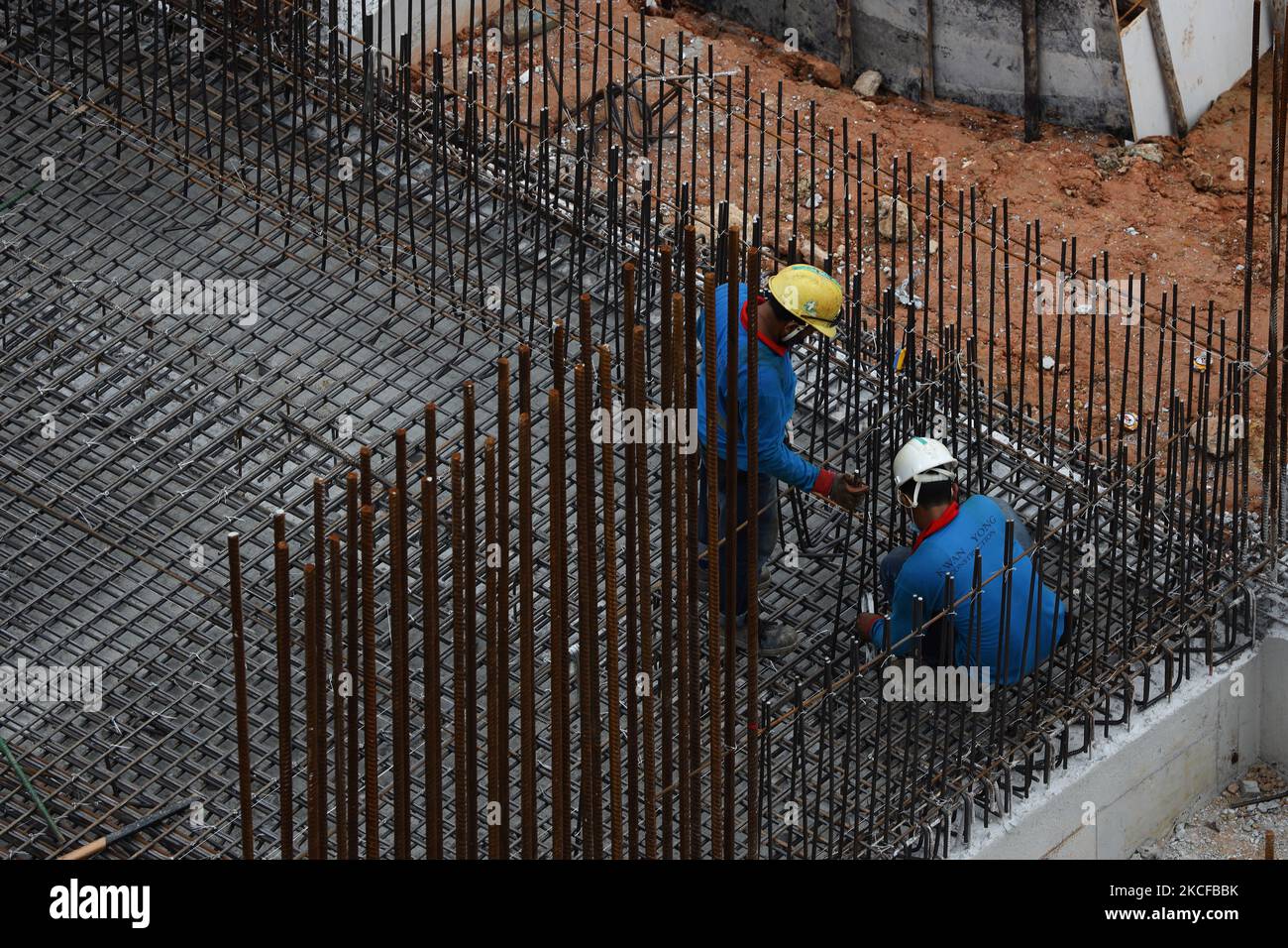 Migrant workers work at a building construction site on May 29, 2021 in ...