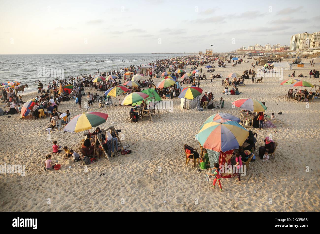 Hundreds of Palestinian people gather in Gaza Beach to cool off on a ...