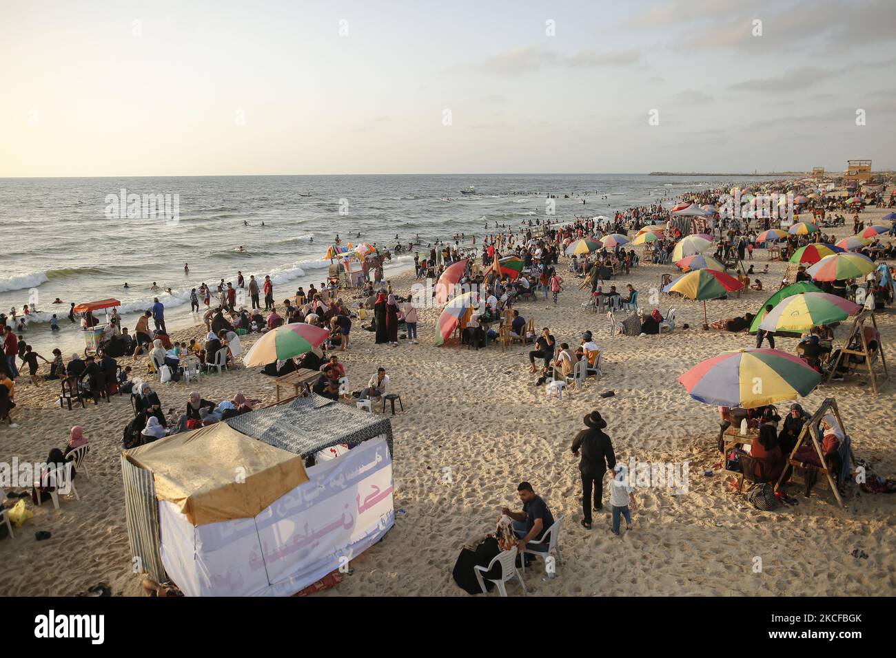 Hundreds of Palestinian people gather in Gaza Beach to cool off on a ...