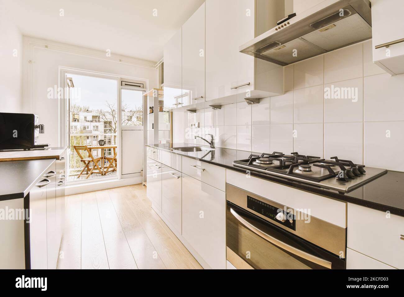 Spacious attic room of apartment with dining table and chairs near open ...