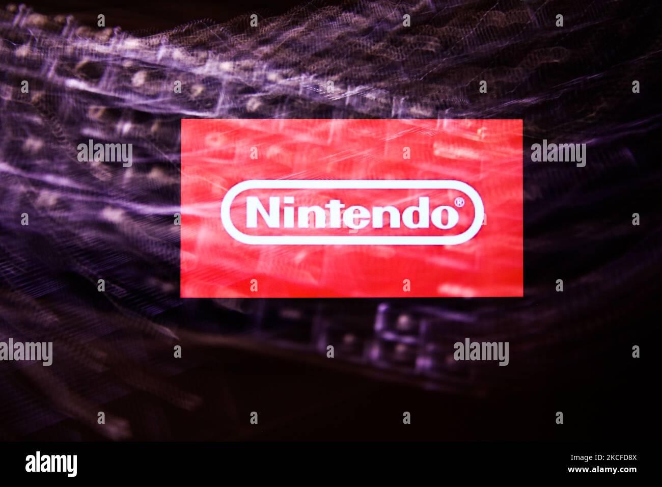 Nintendo logo displayed on a phone screen and a keyboard are seen in ...