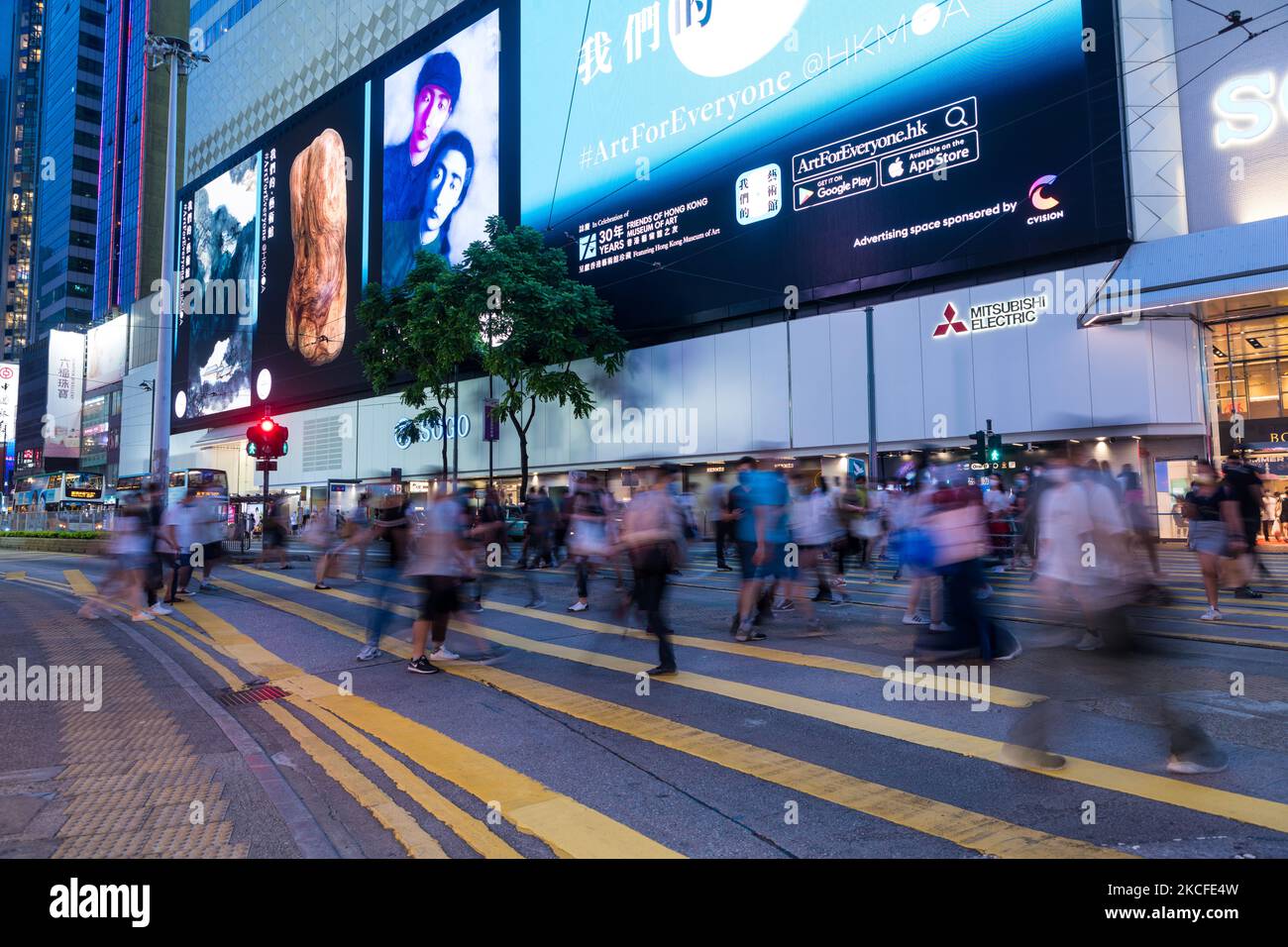 People cross the street in Causeway Bay, in Hong Kong, China, on May 30 ...