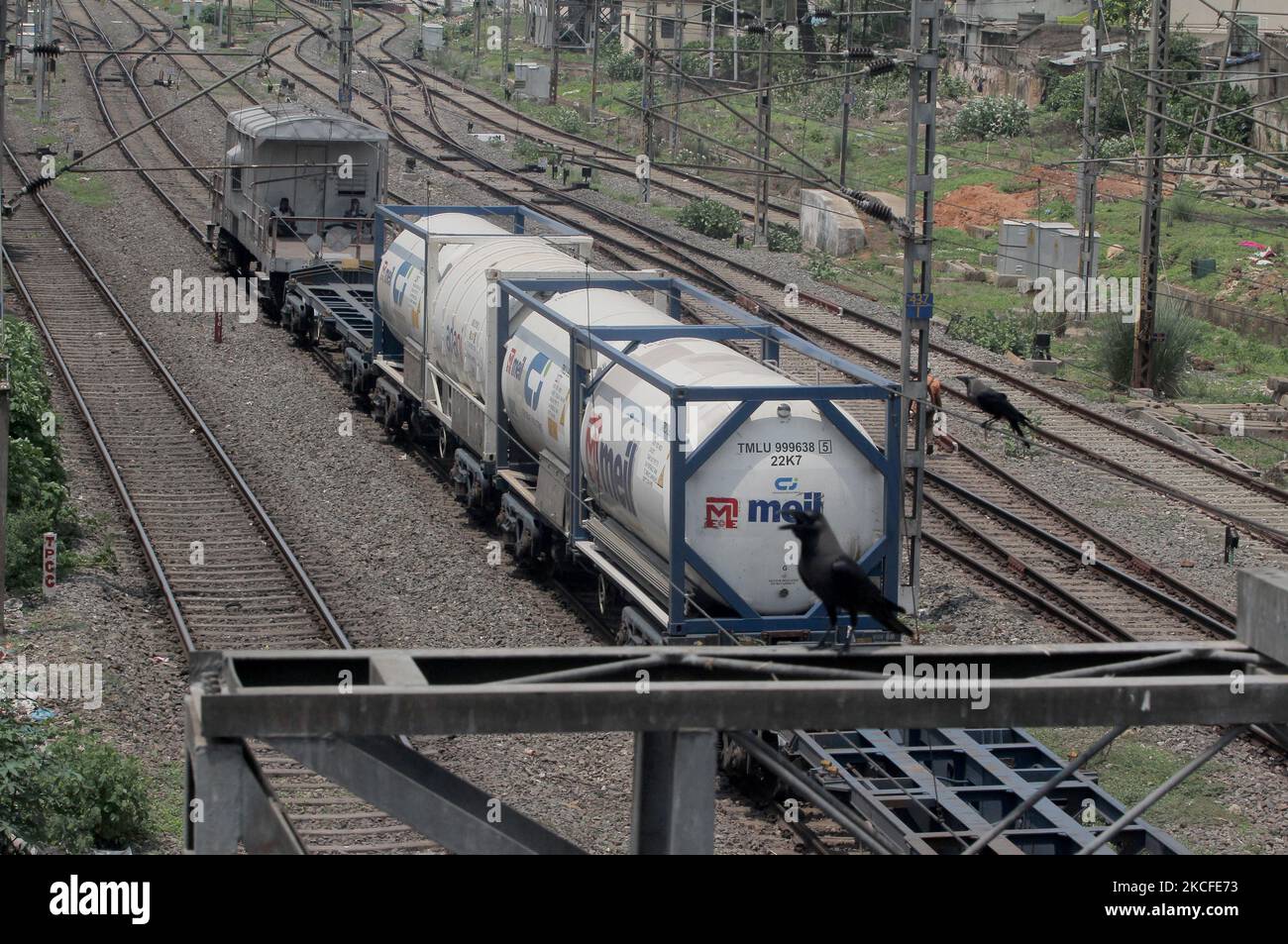 Oxygen loaded tanks are seen as it is moves past the city railway ...